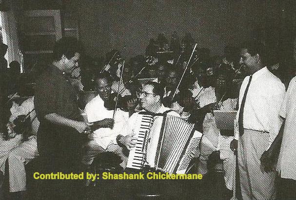 Shankar Jaikishan discussing with musicians in the recording studio ...