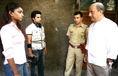 Deepal Shaw with Amir Bashir (2nd R) and Anupam Kher in a still from ...