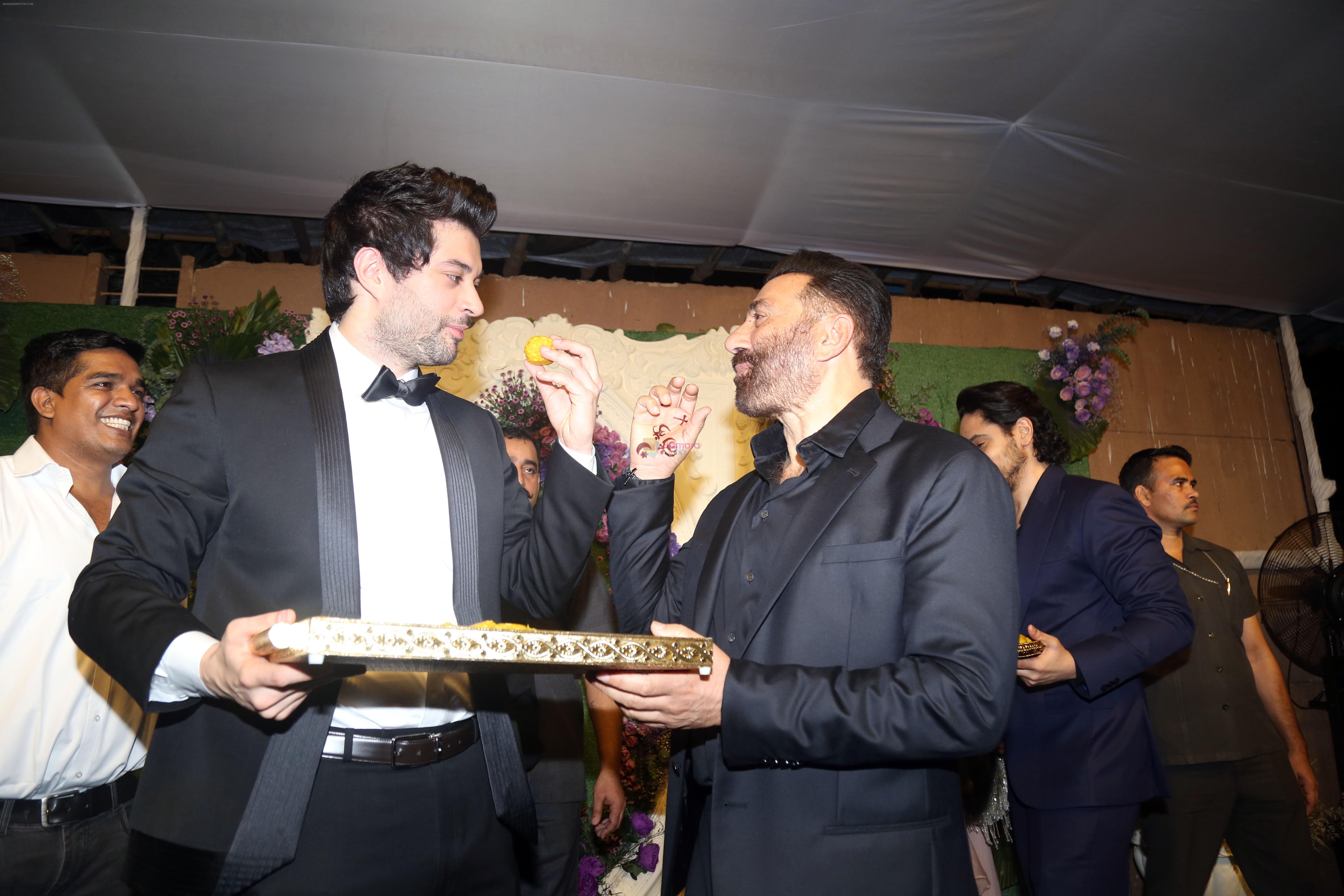 Sunny Deol and Rajveer Deol Pose for media at the reception of Karan ...
