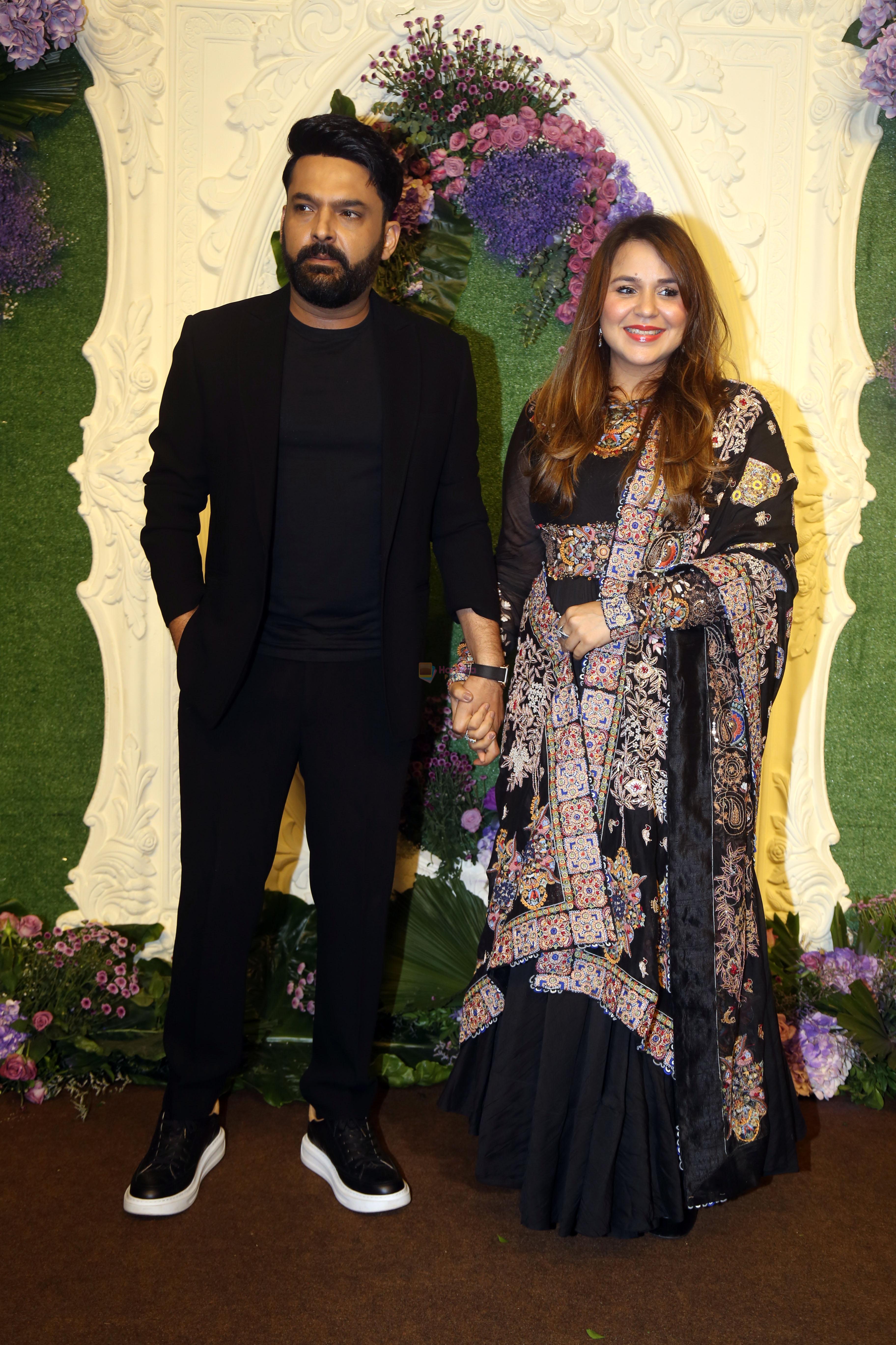 Kapil Sharma with wife Ginni Chatrath Pose for media at the reception ...