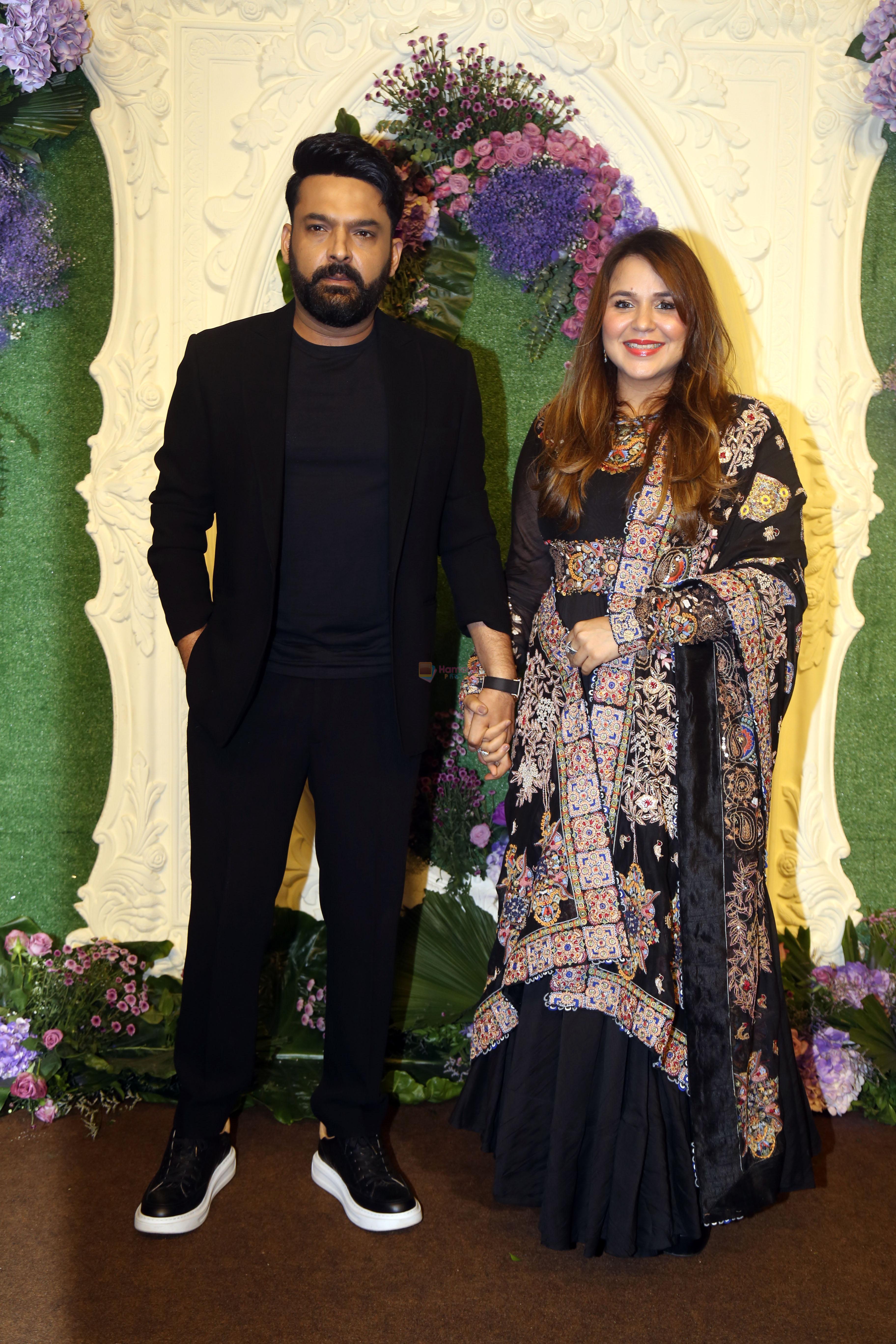 Kapil Sharma with wife Ginni Chatrath Pose for media at the reception ...
